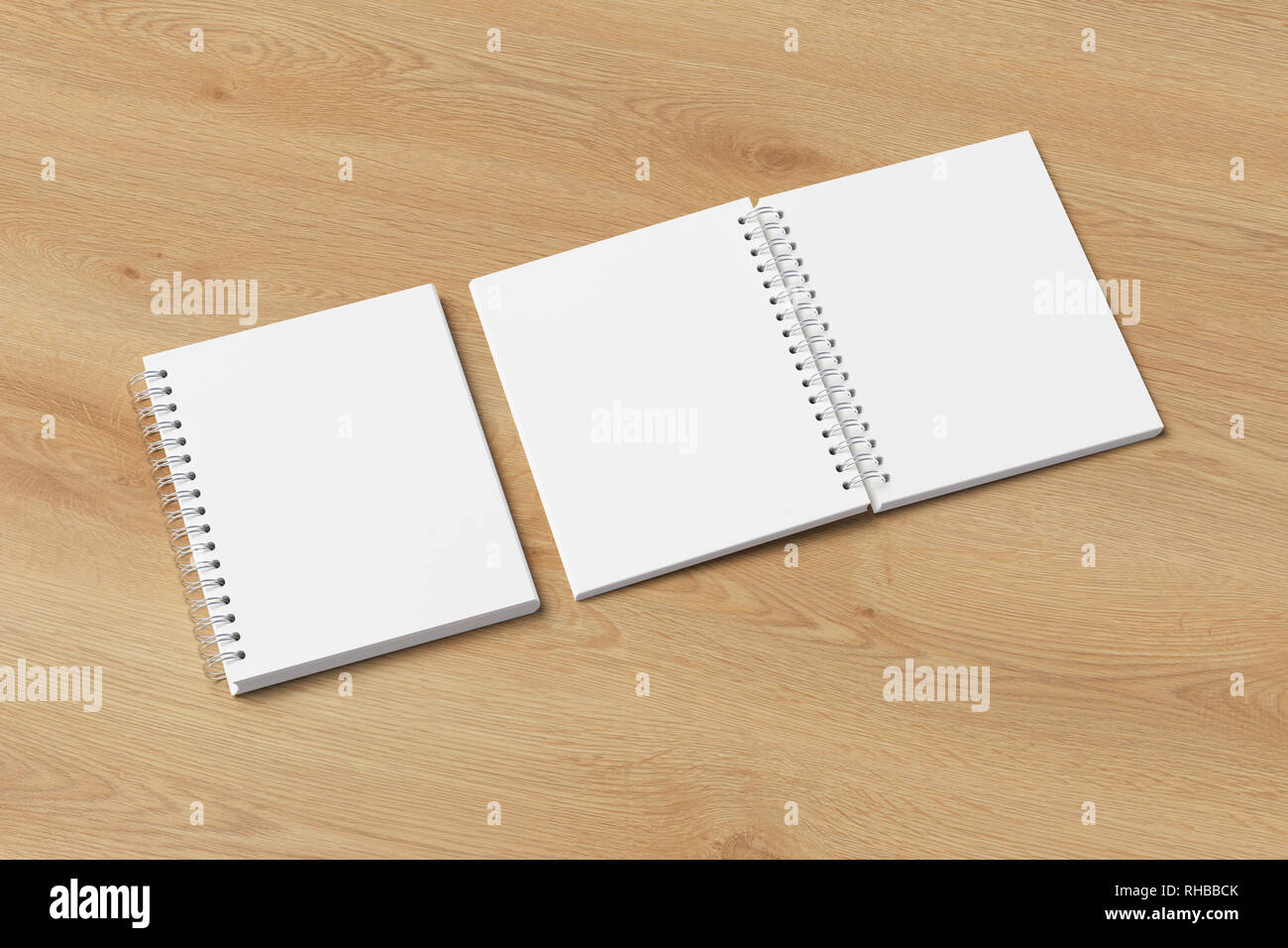Blank open and closed vertical spiral notepads on wooden background ...