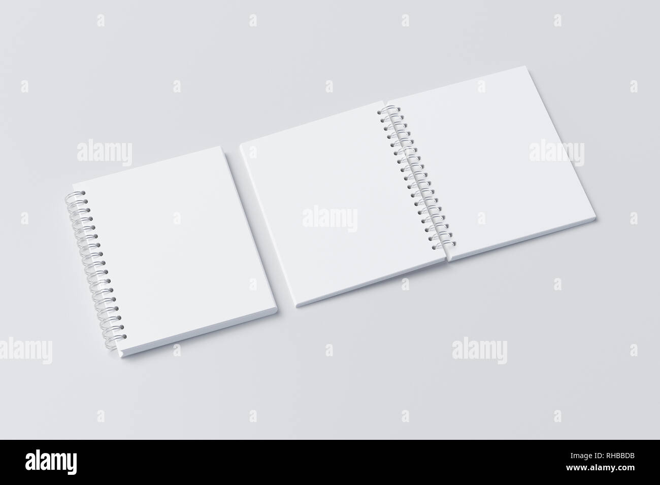 Blank open and closed vertical spiral notepads on white background ...