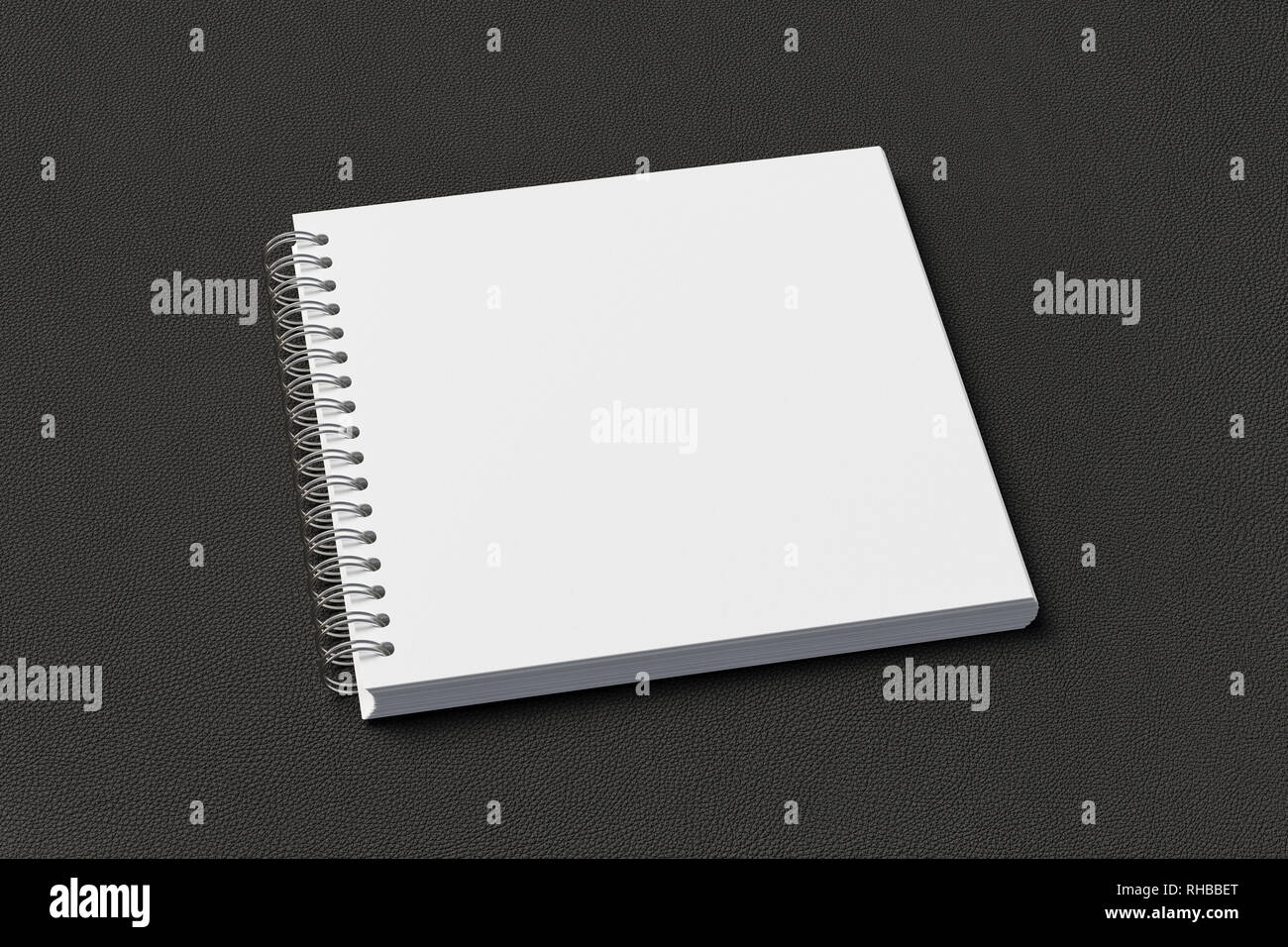 Blank square spiral notepad on black background. With clipping path ...