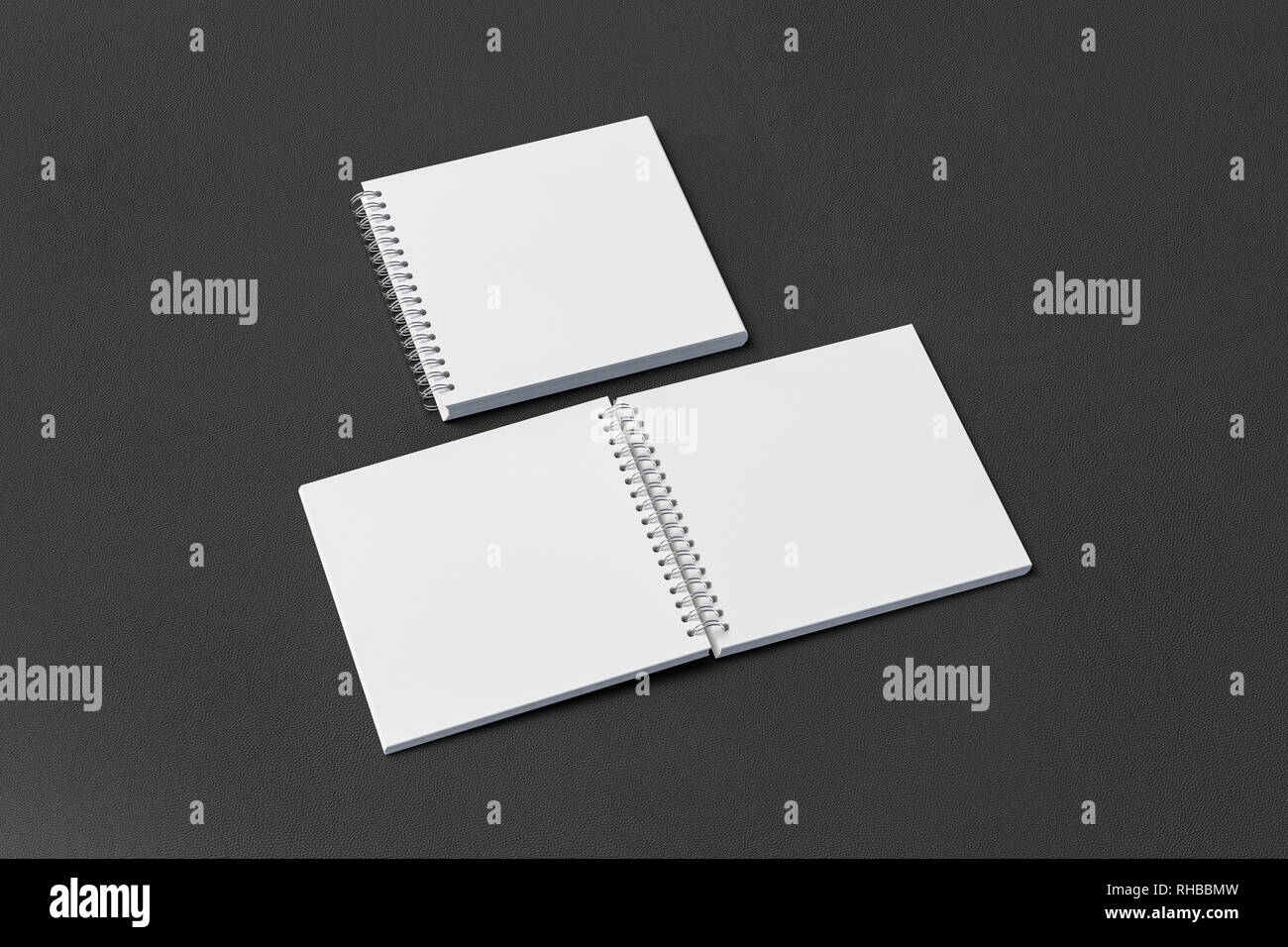 Blank open and closed square spiral notepad on black background. With ...