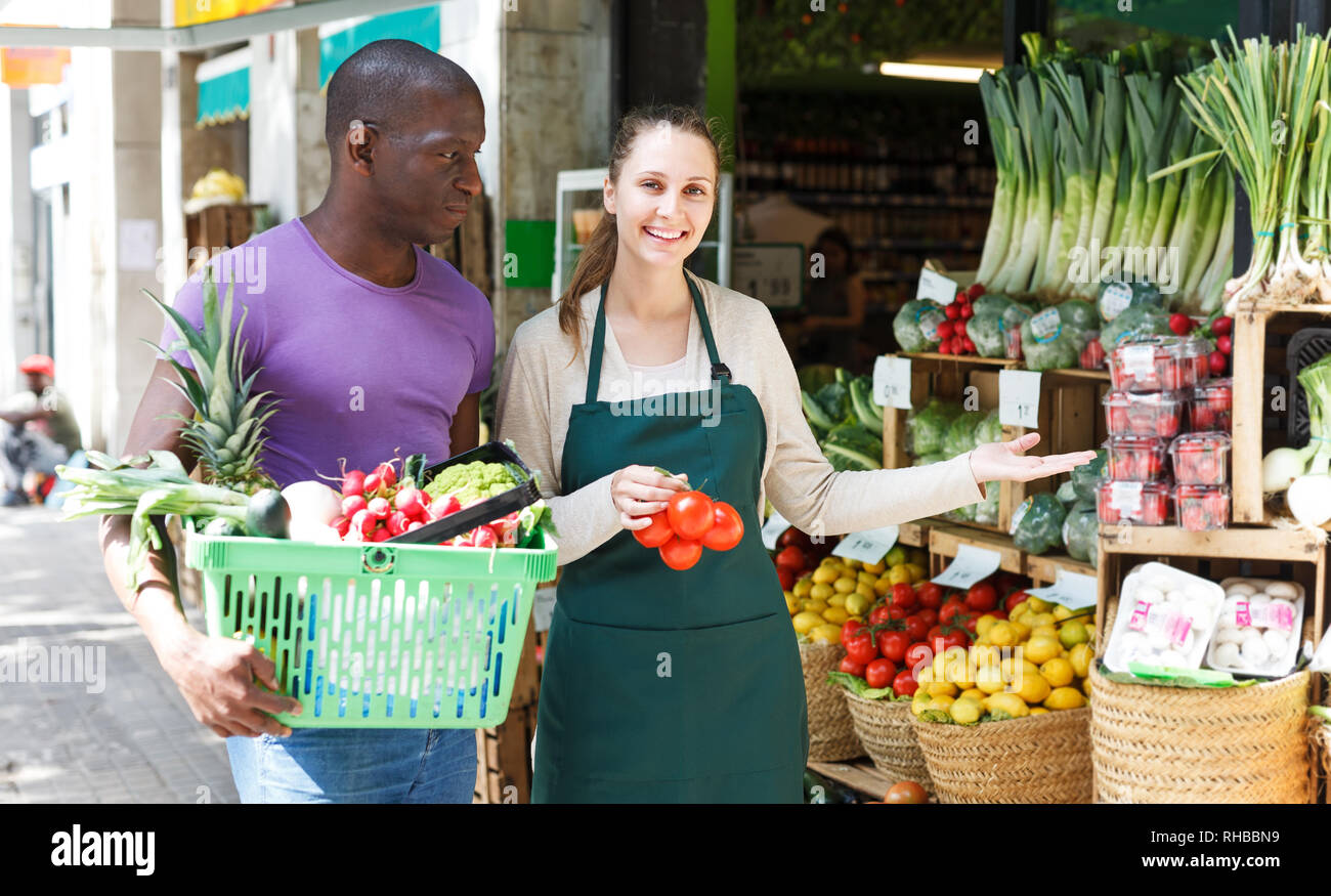 Positive male client is asking from seller female about freshness ...