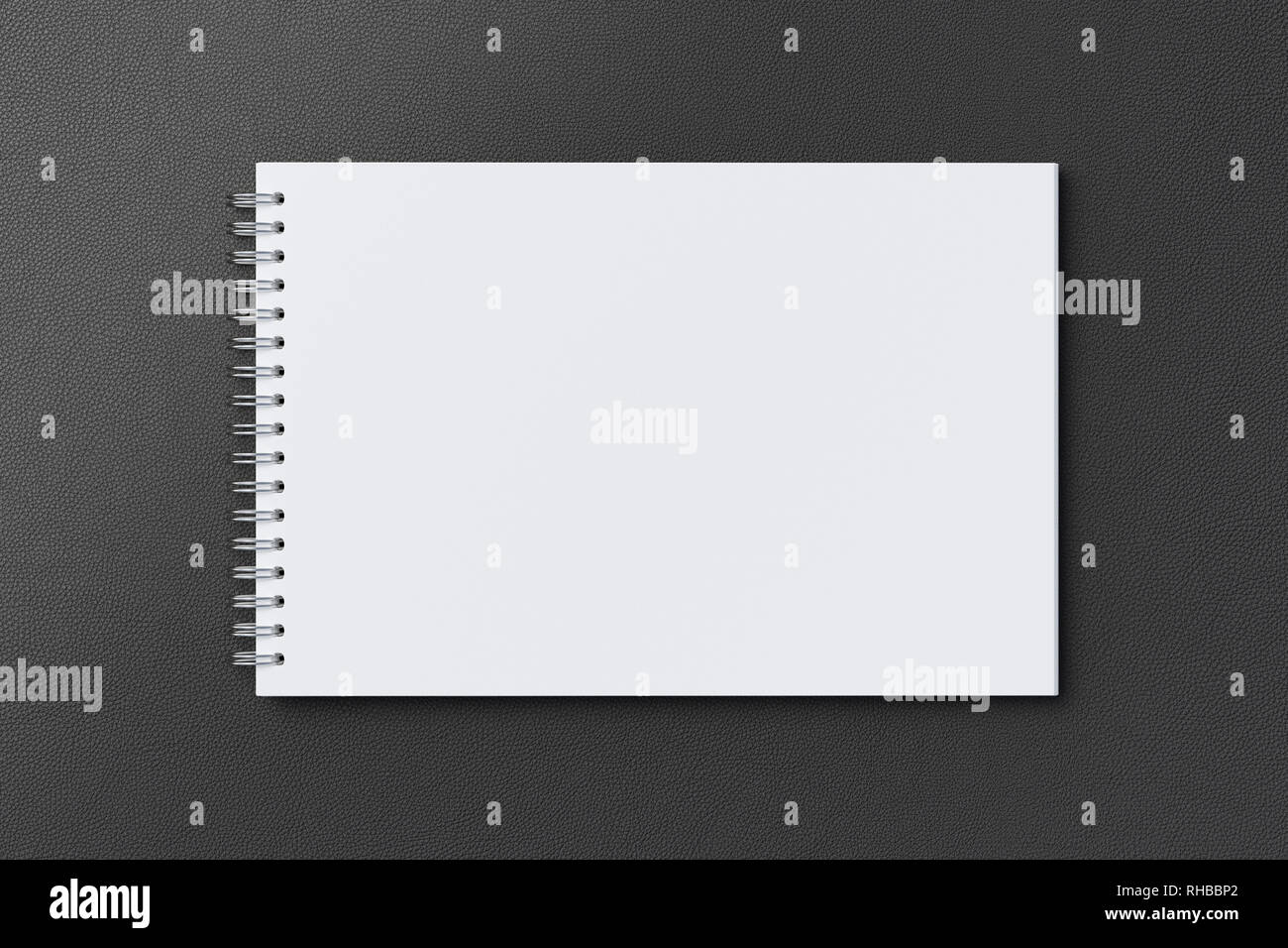 Blank horizontal spiral notepad on black background. With clipping path ...