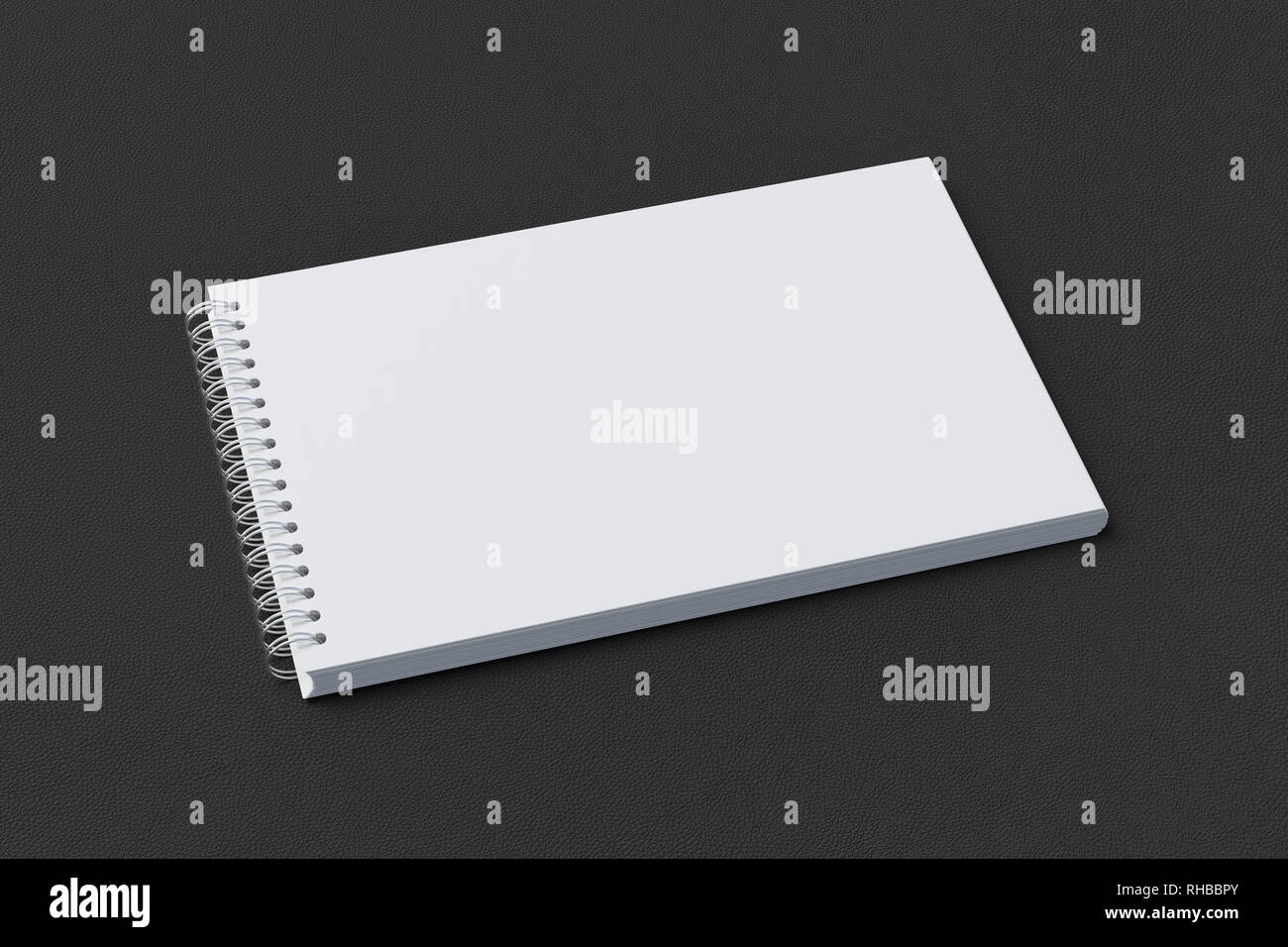 Blank horizontal spiral notepad on black background. With clipping path ...