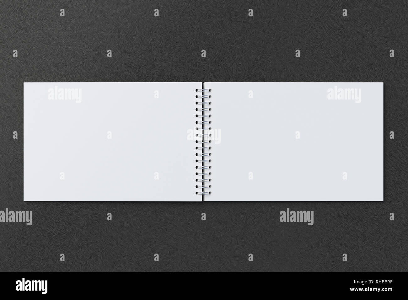 Blank open horizontal spiral notepad on black background. With clipping ...