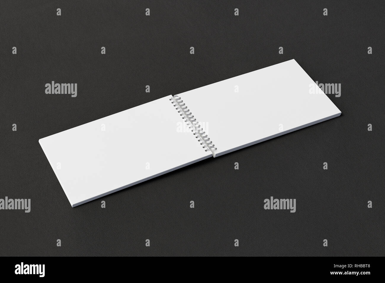 Blank open horizontal spiral notepad on black background. With clipping ...