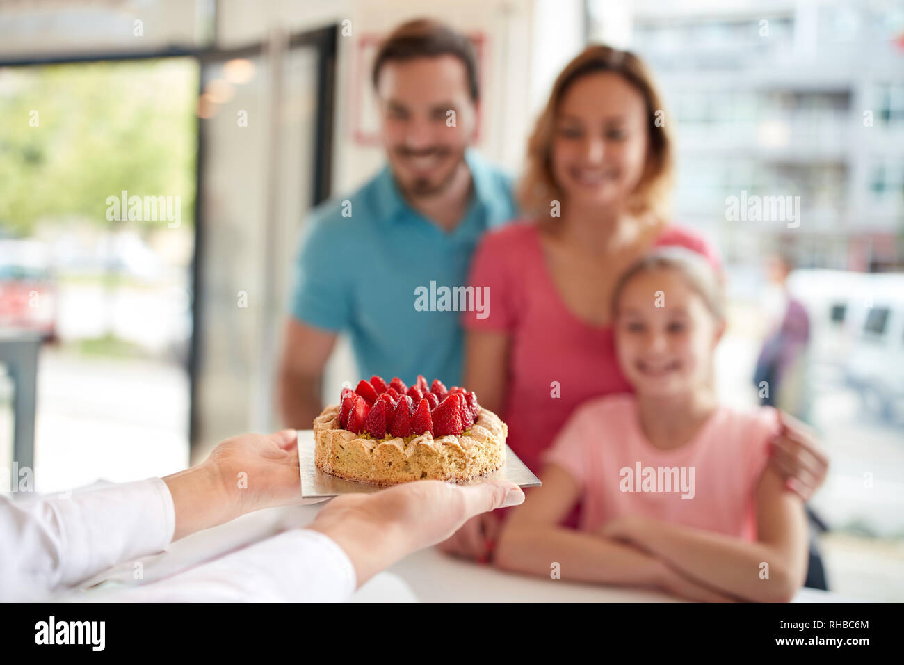 Sweet strawberries cake for girl with parents in confectionery Stock ...