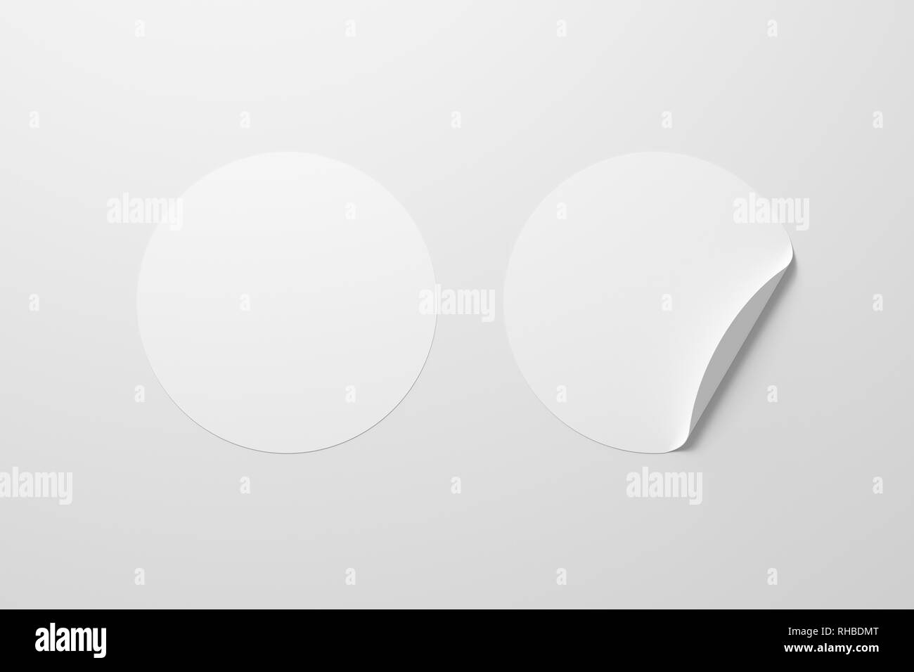 Blank white round stickers straightened and with folded corner on white ...
