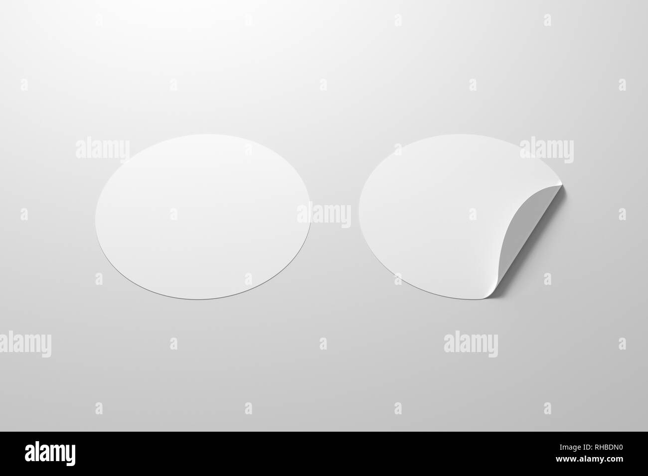 Blank white round stickers straightened and with folded corner on white ...