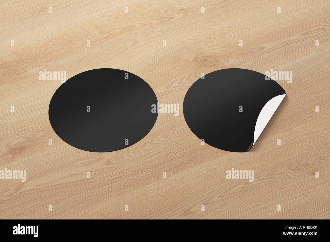 Blank black round stickers straightened and with folded corner on ...
