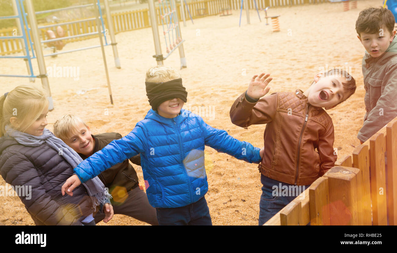 Children active games. Happy kids playing blind man bluff on playground ...