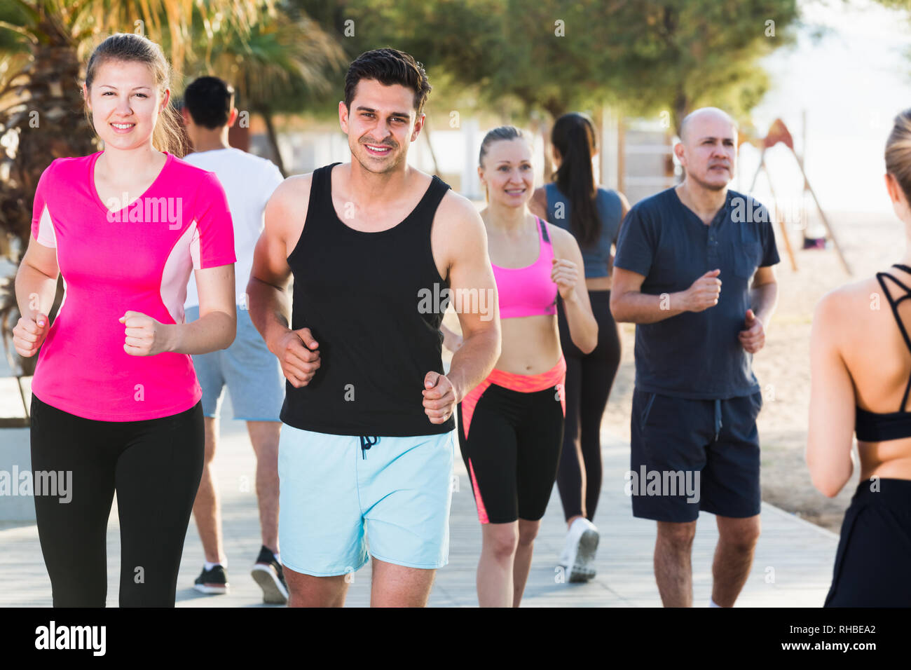 Active smiling people during running training in daytime Stock Photo ...