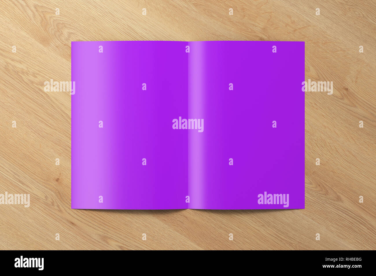 Blank violet half-folded flyer leaflet on wooden background. With clipping path around brochure ...