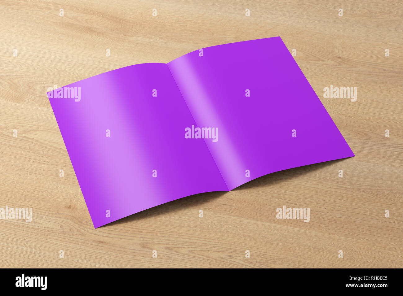 Blank violet half-folded flyer leaflet on wooden background. With clipping path around brochure ...