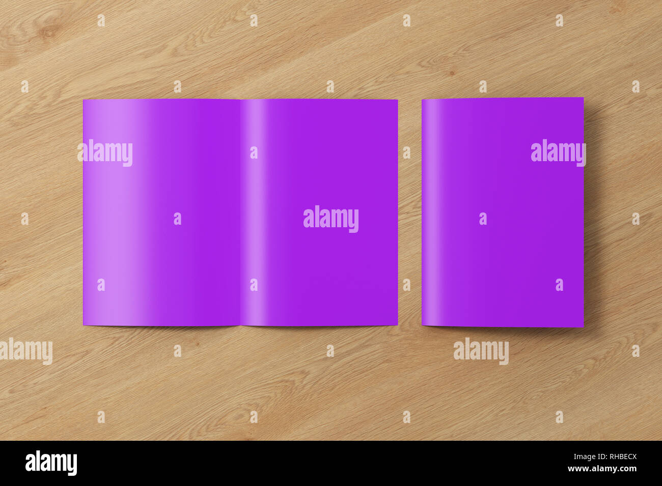 Blank violet open and folded half-folded flyer leaflet on wooden background. With clipping path ...
