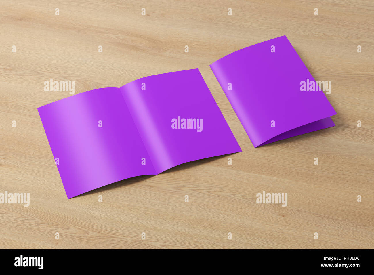 Blank violet open and folded half-folded flyer leaflet on wooden background. With clipping path ...