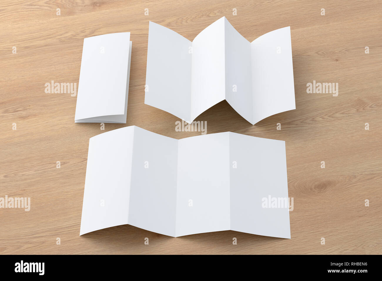 Blank folded paper leaflet on wooden background. Eight pages, four ...