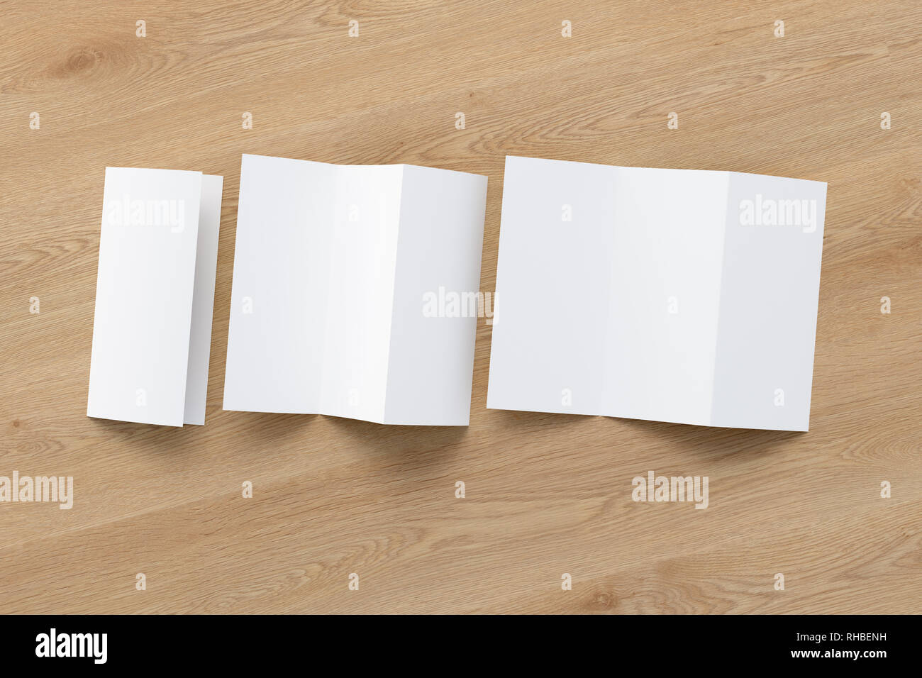 Blank trifold paper leaflet on wooden background. Six pages, three ...
