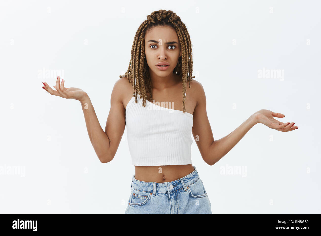 Portrait of confused intense and pissed young dark-skinned woman with ...