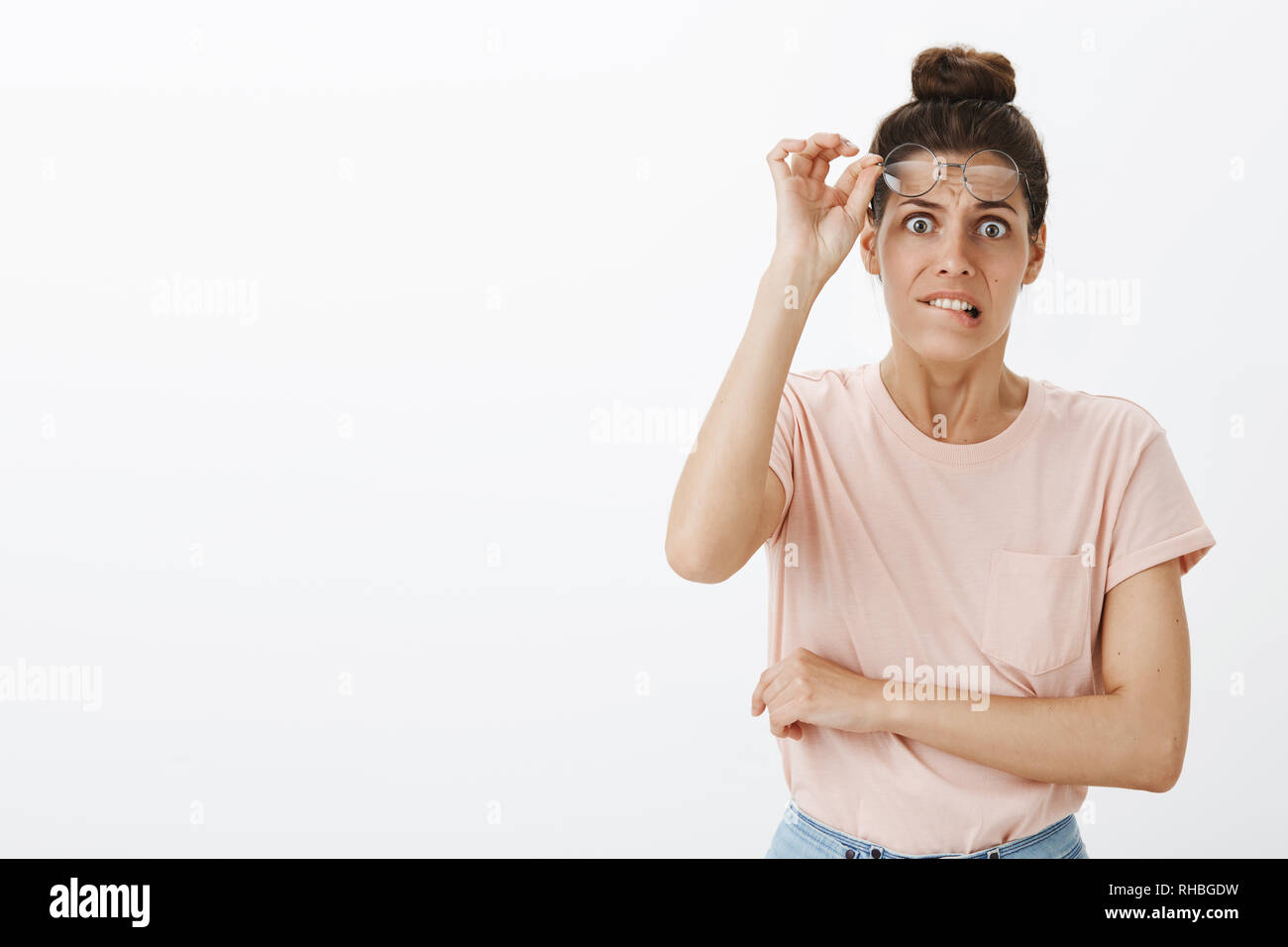 Waist-up shot of scared worried and insecure young silly woman taking ...
