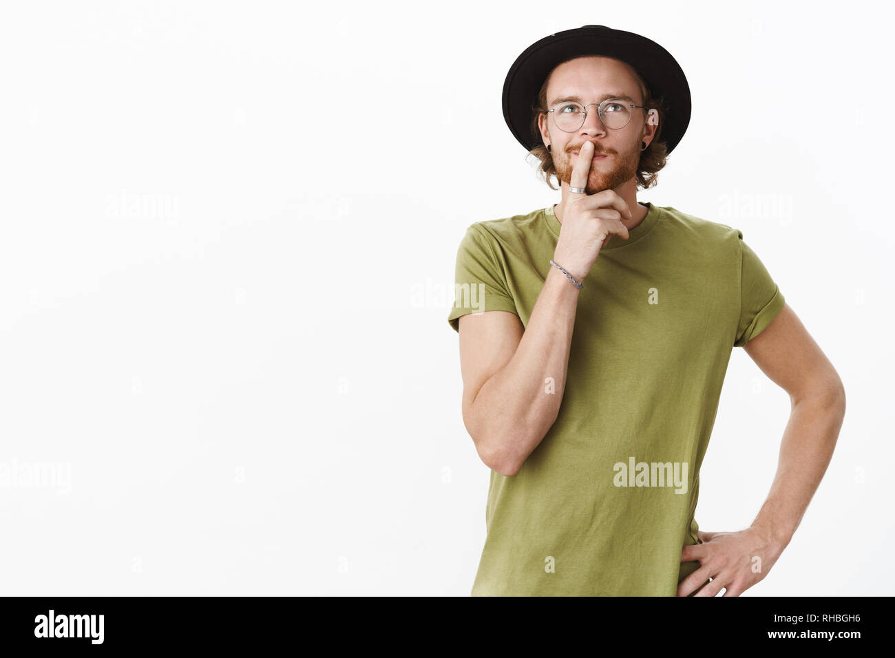 Waist-up shot of man thinking what he desire to eat, chosing restaurant ...