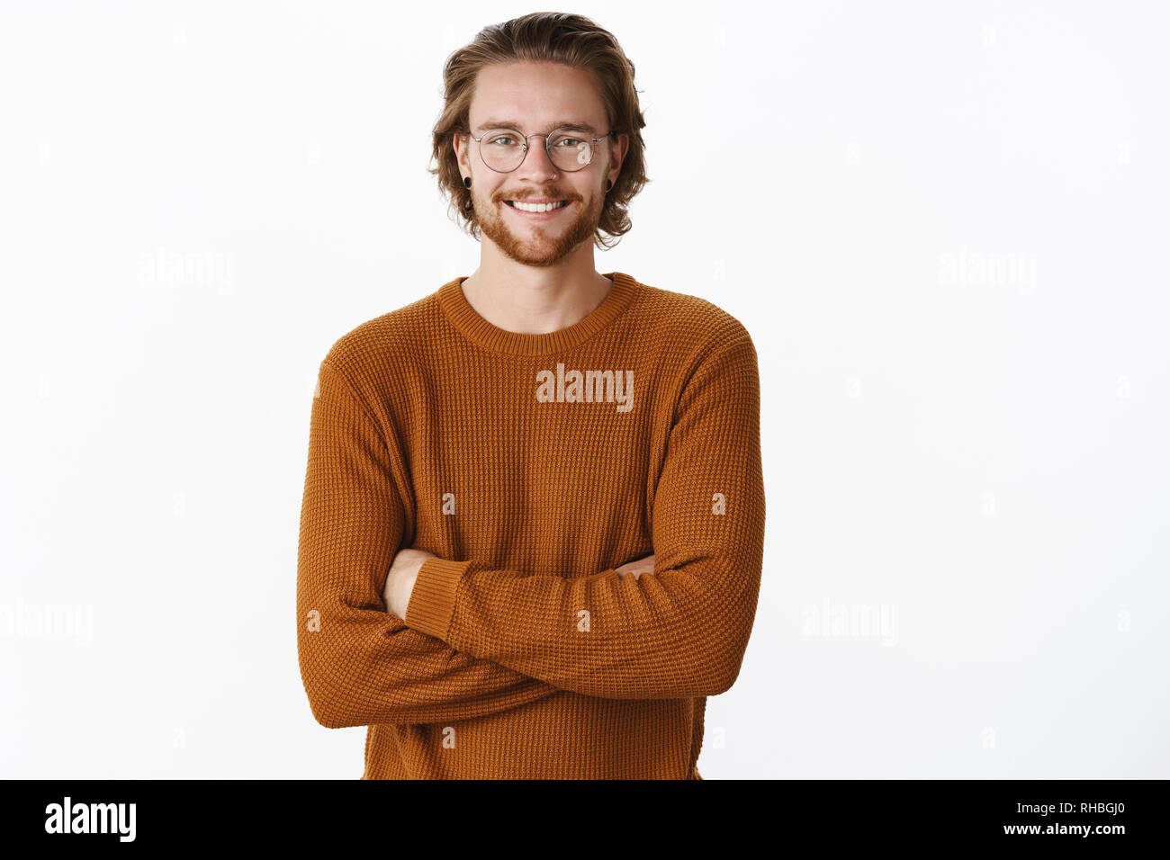 Waist-up shot of satisfied successful male programmer in glasses with ...