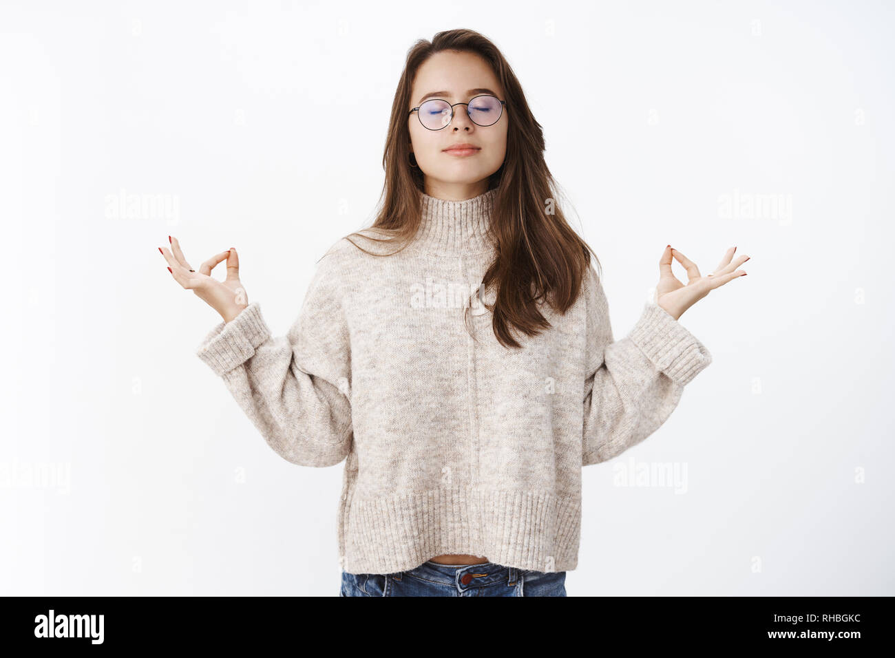 Charming relieved, happy girl releasing stress as meditating with ...
