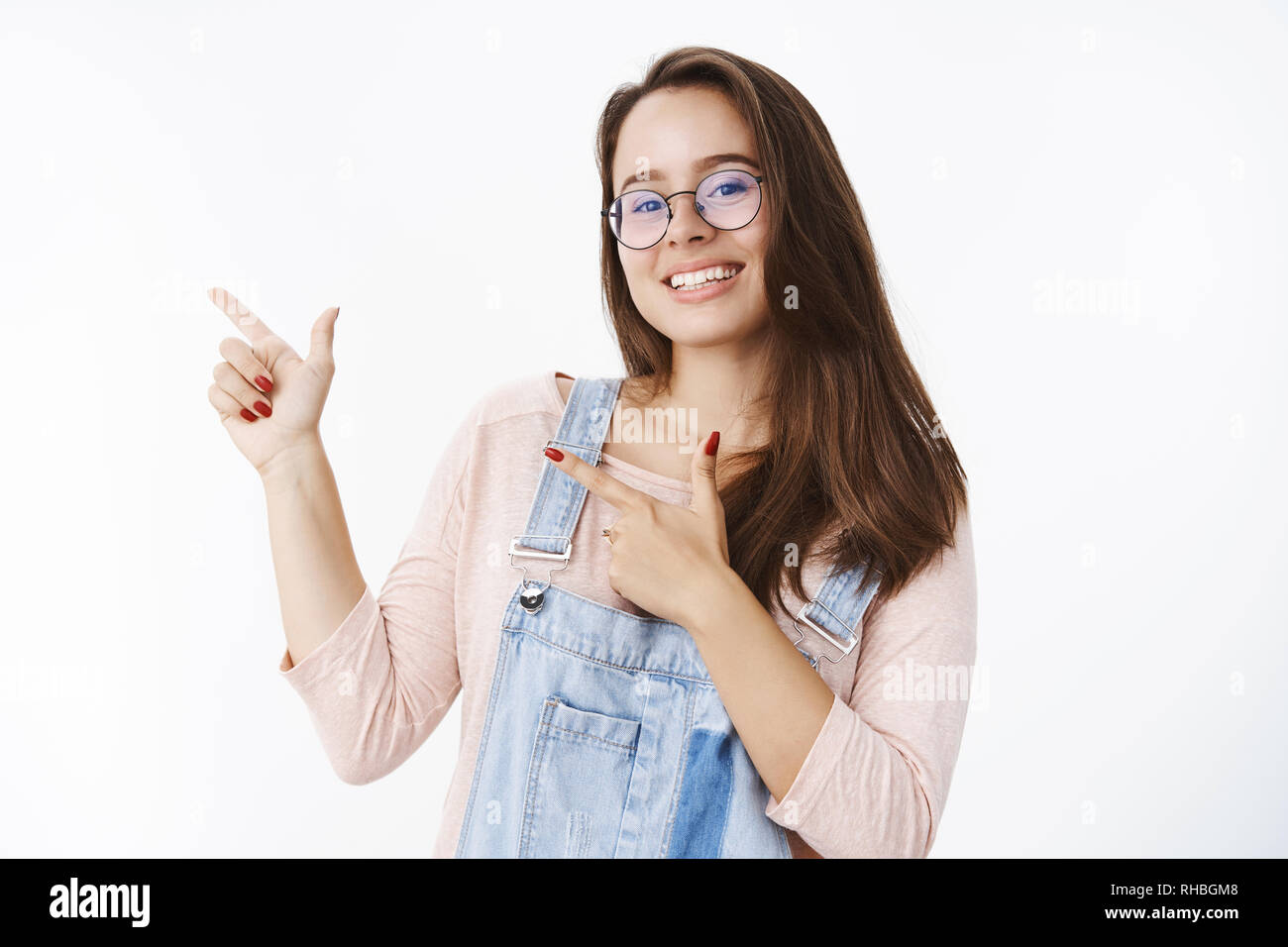 Waist-up shot of friendly-looking happy satisfied female in glasses and ...