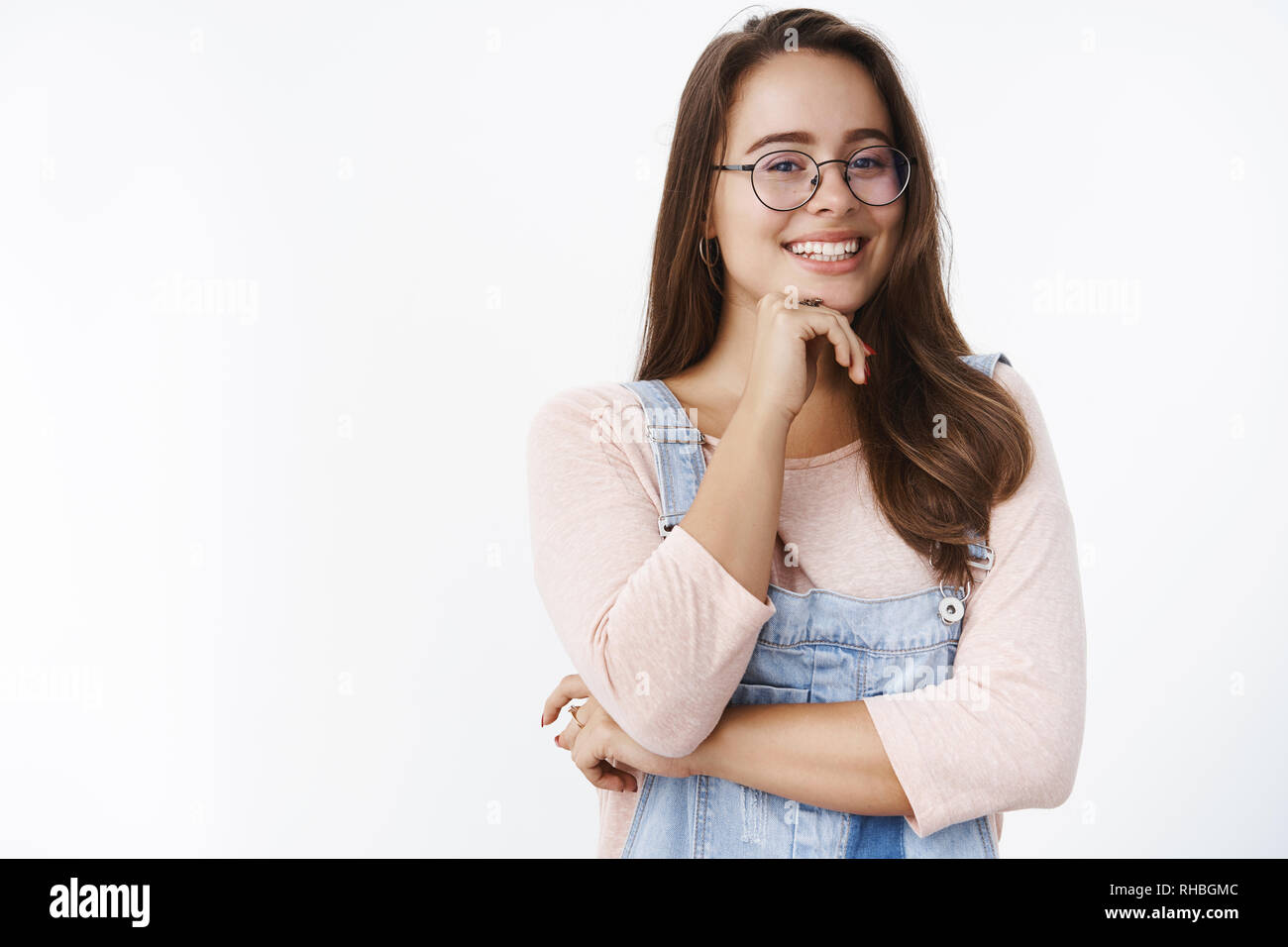 Waist-up shot of charming amused and cute young female with brown hair ...