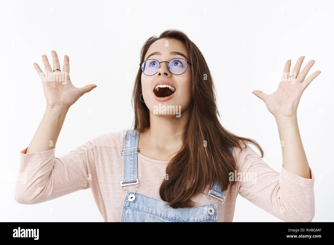 Happy excited woman thanking god as looking at sky with raised hands ...
