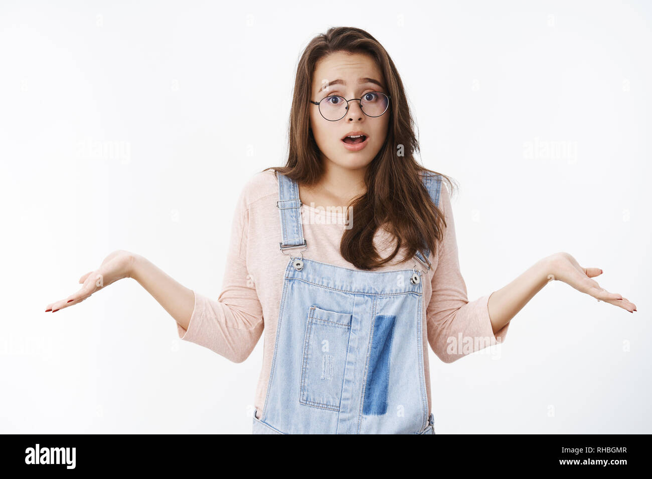 Why me. Portrait of confused and clueless clumsy cute woman in glasses ...