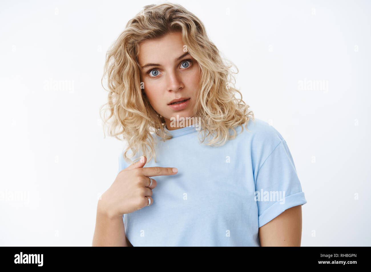 Who, me. Portrait of questioned and shocked woman point at herself ...