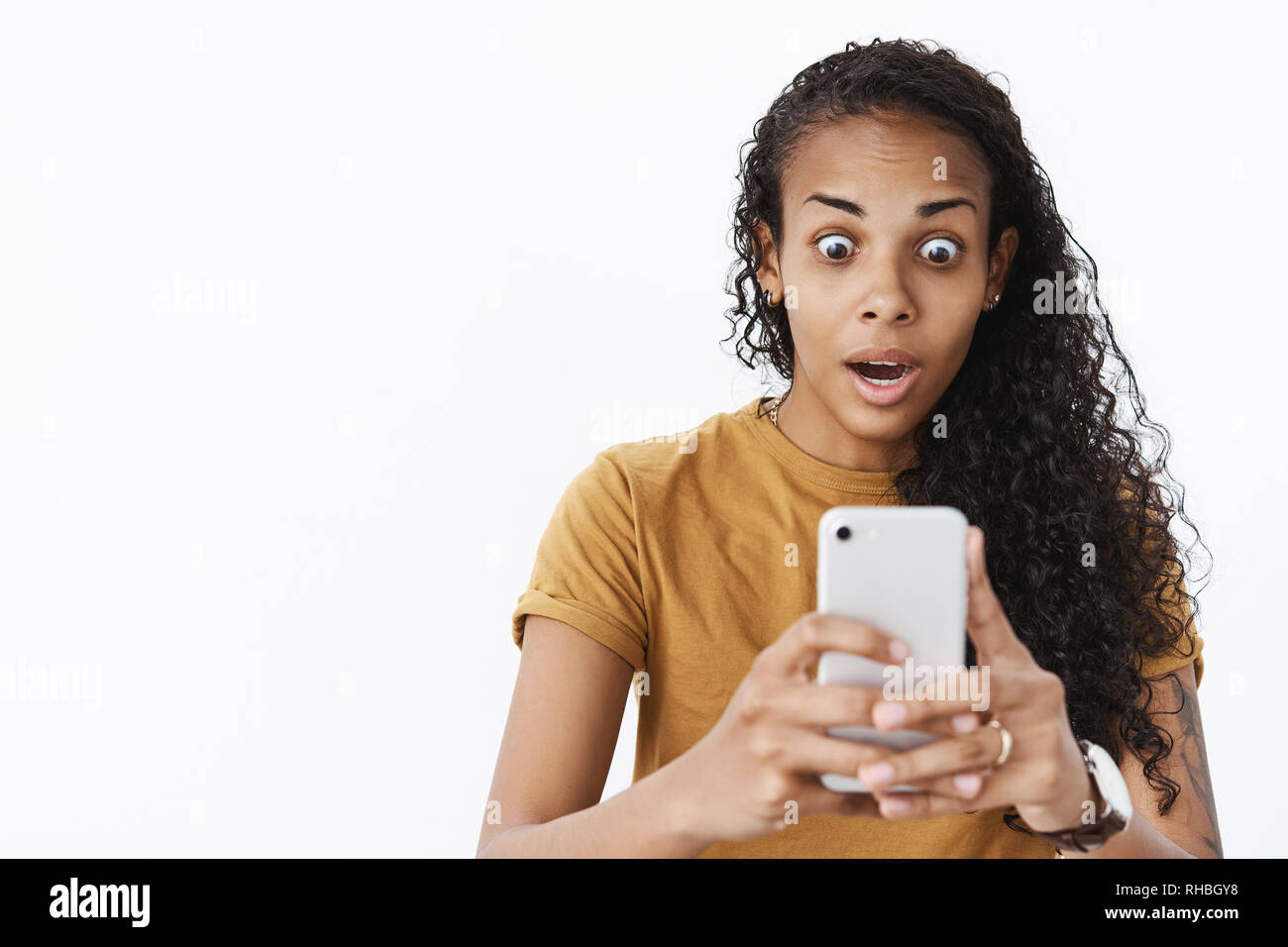 Waist-up shot of shocked astonished and speechless african american ...