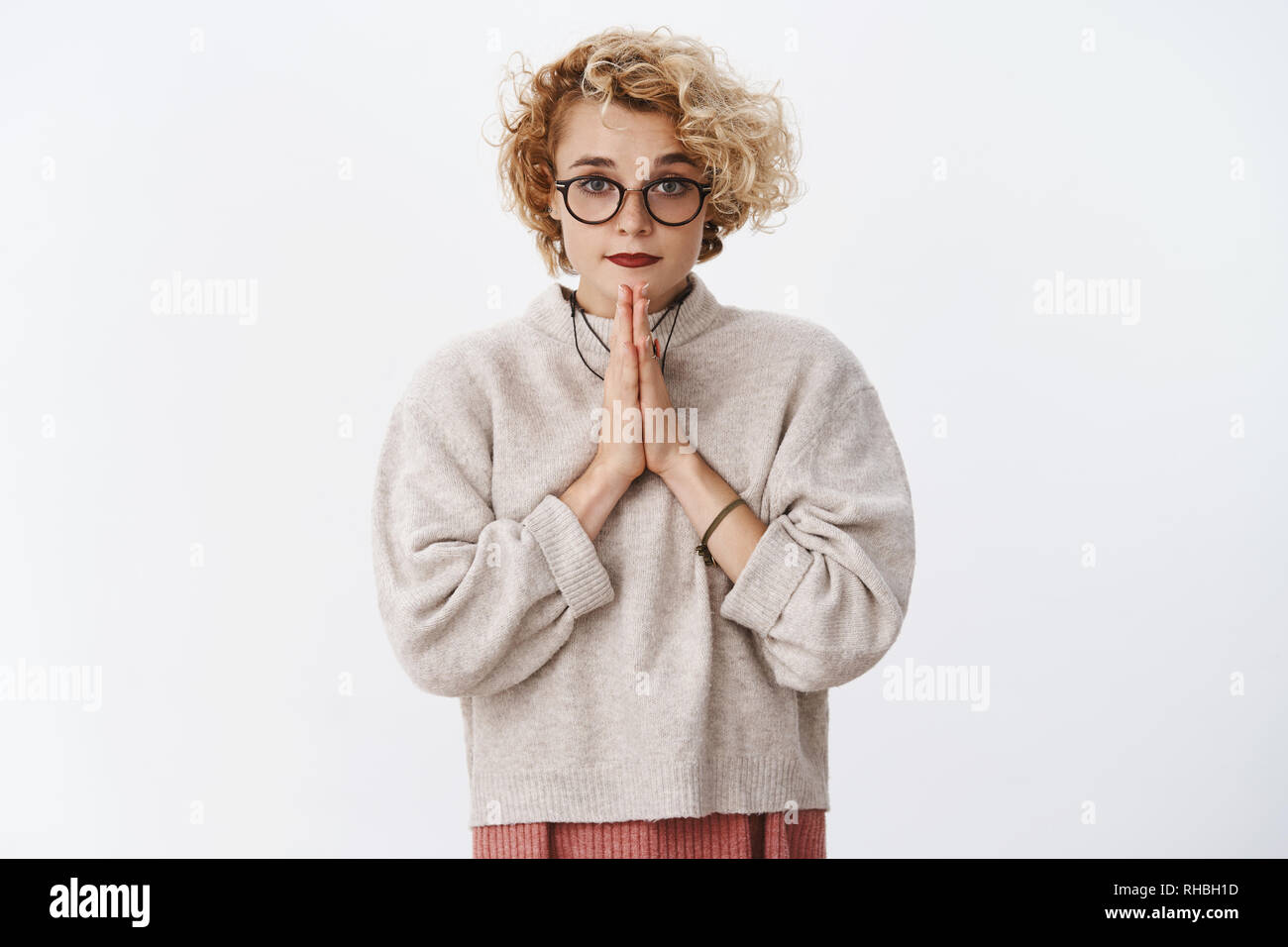 Intense serious and hopeful young charming european woman in glasses ...