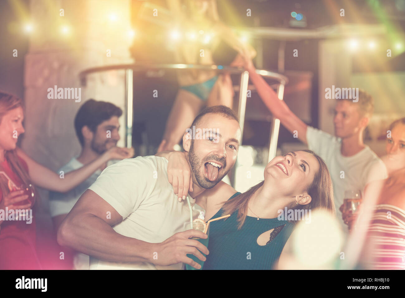 Couple of smiling people together in the night club with drinks Stock ...