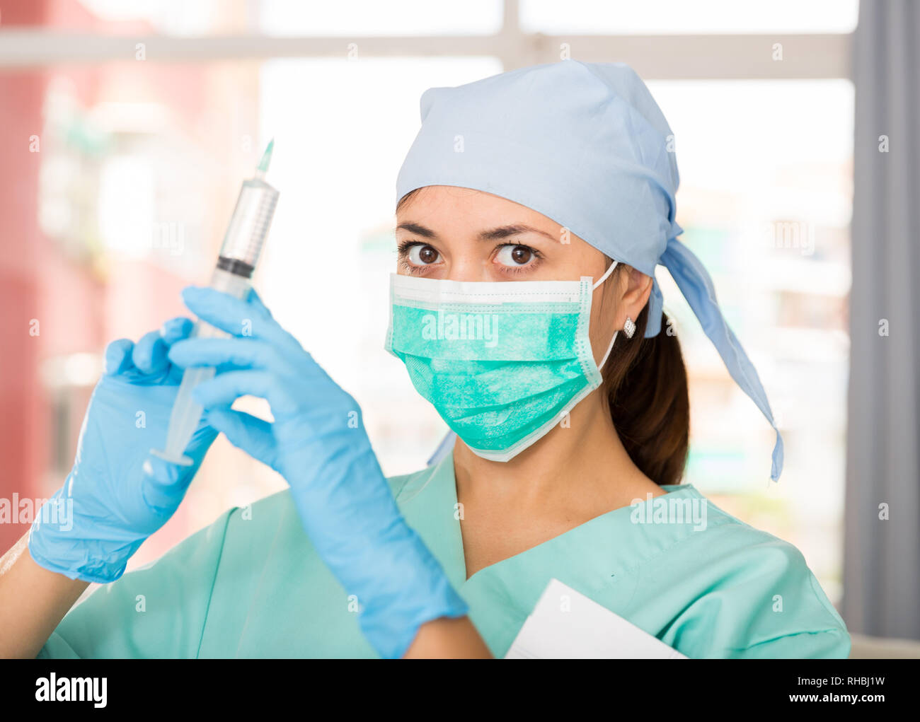 Professional nurse young woman making injection in modern hospital ...