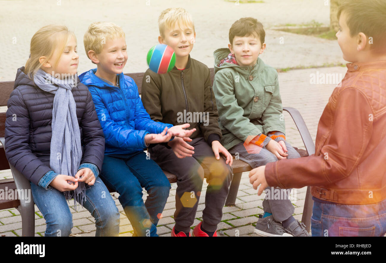 Kids playing ball together on the street Stock Photo - Alamy