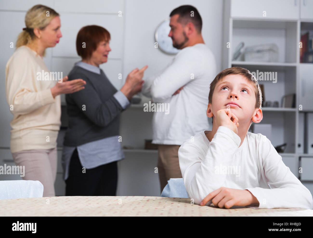 Upset tired son suffering from parental arguing at home Stock Photo - Alamy
