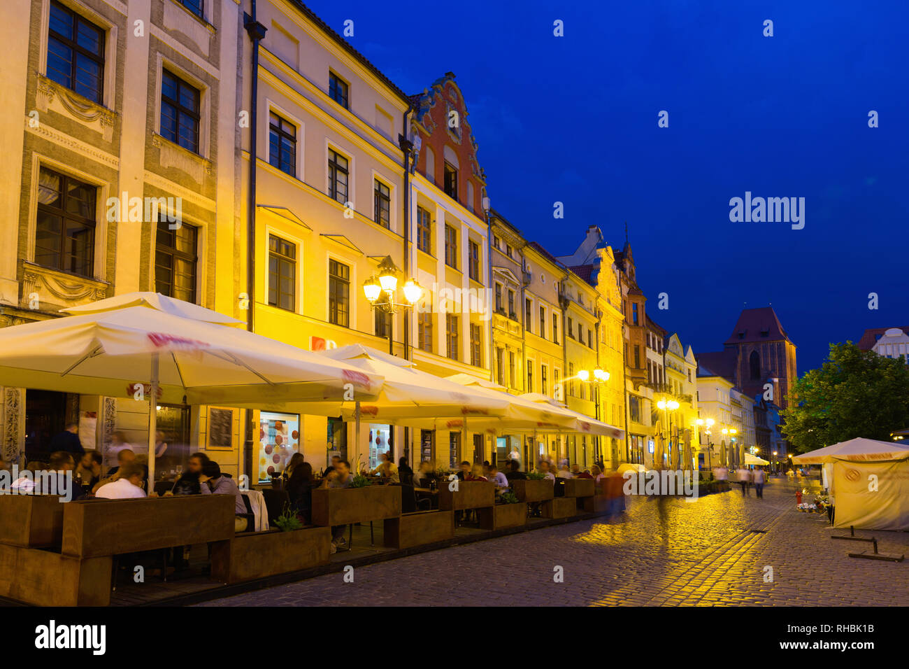 Nightlife of lighted Torun streets in warm spring, Poland Stock Photo ...