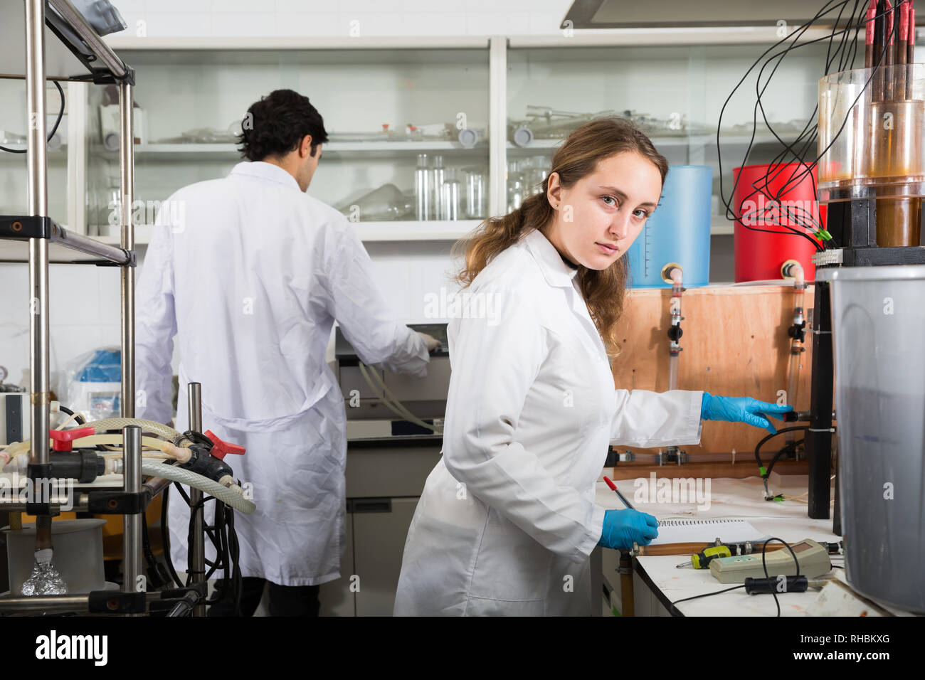 Female scientist using lab equipment during research in chemical ...