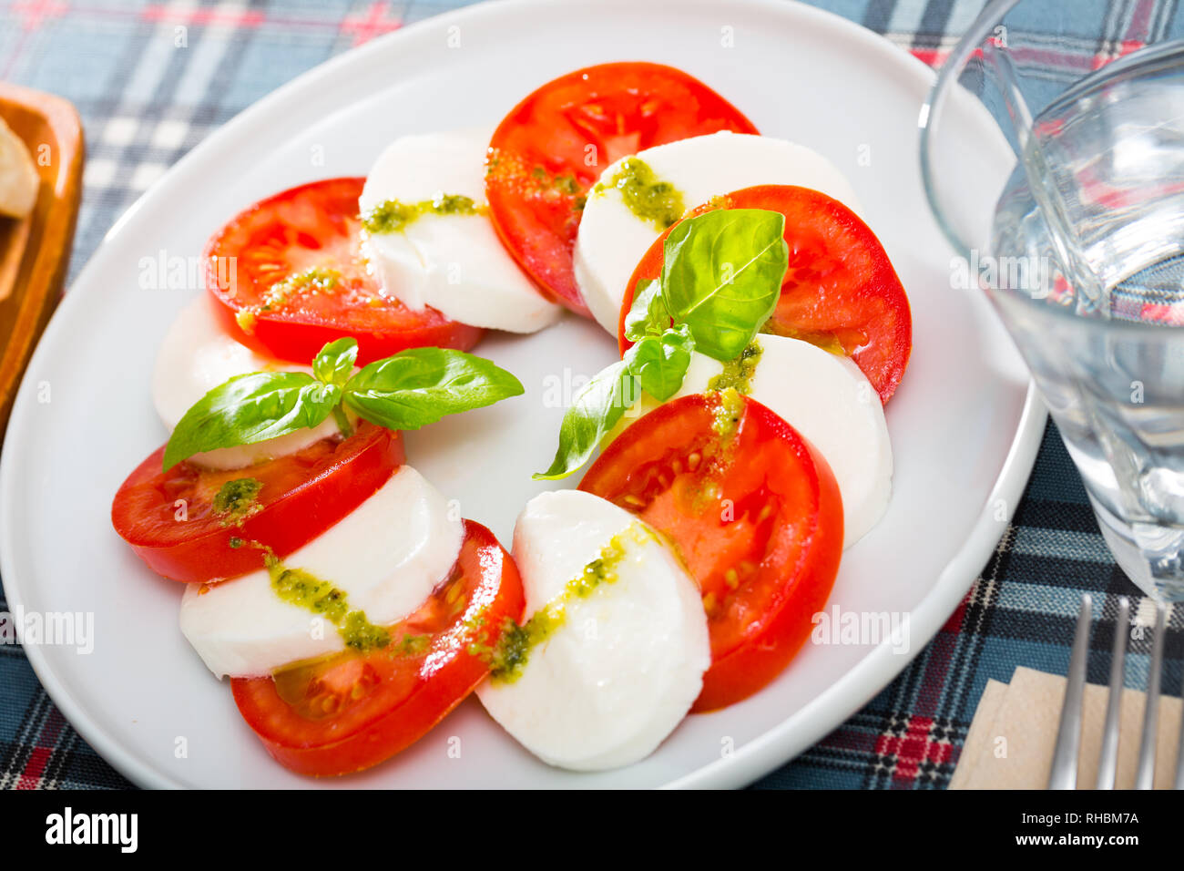 Caprese salad with fresh tomatoes, mozzarella cheese and basilic herb ...
