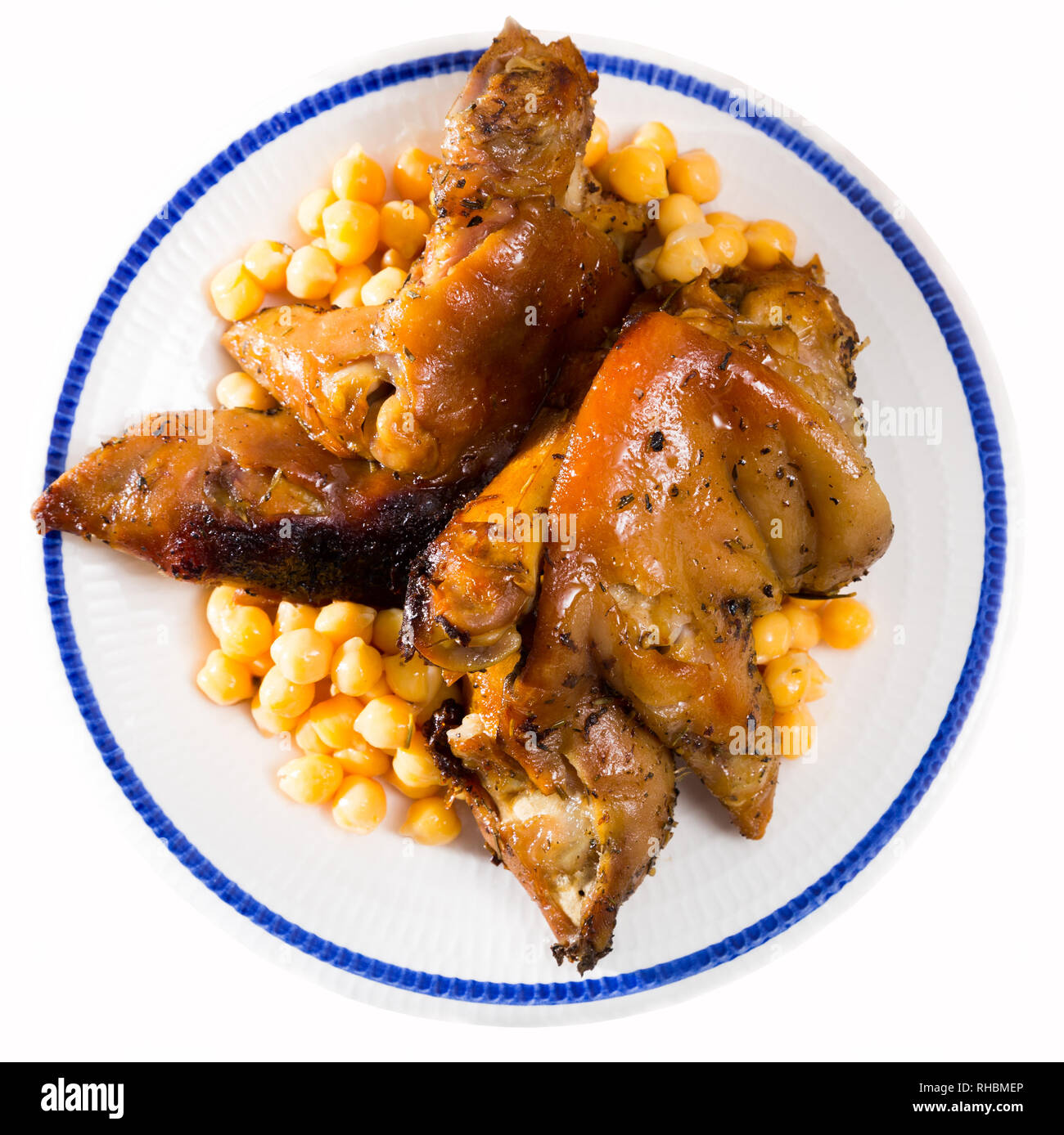 Top view of appetizing fried pig legs with stewed chickpeas served on ...