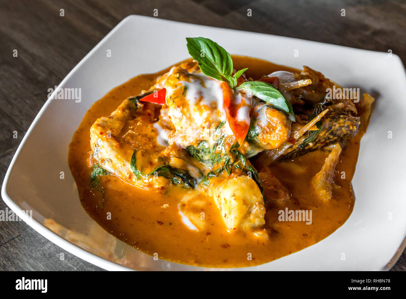 Fried grouper Fish with Red Curry Paste Chu Chee Pla Stock Photo - Alamy
