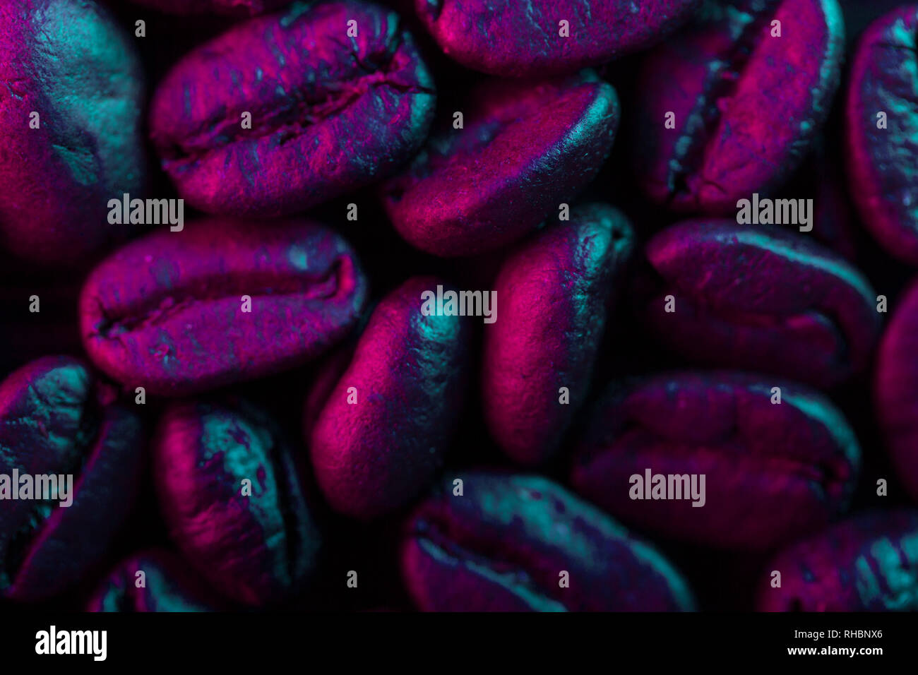 Roasted coffee bean close up in neon light background Stock Photo - Alamy