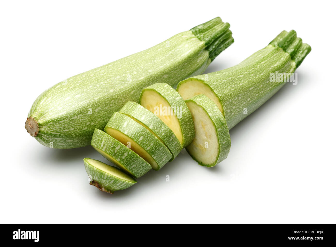 Fresh zucchini with slices isolated on white background Stock Photo - Alamy