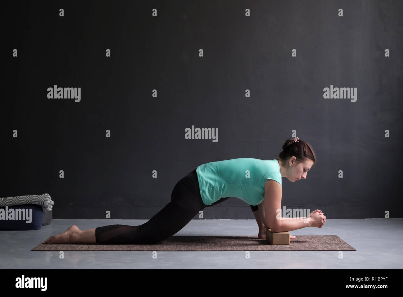Young slim girl, doing horse rider exercise, anjaneyasana pose, working ...