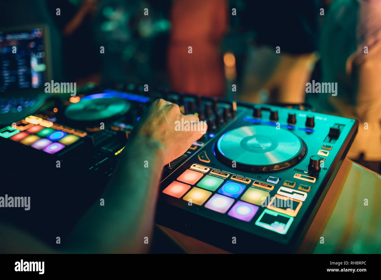 DJ plays live set and mixing music on turntable console at stage in the ...