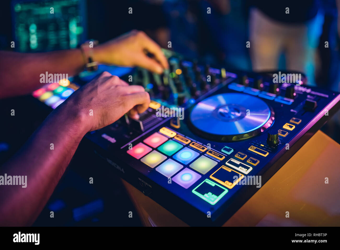 DJ plays live set and mixing music on turntable console at stage in the ...