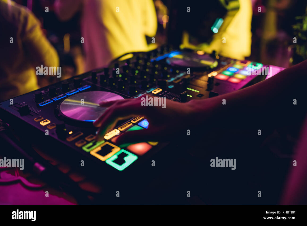 DJ plays live set and mixing music on turntable console at stage in the ...