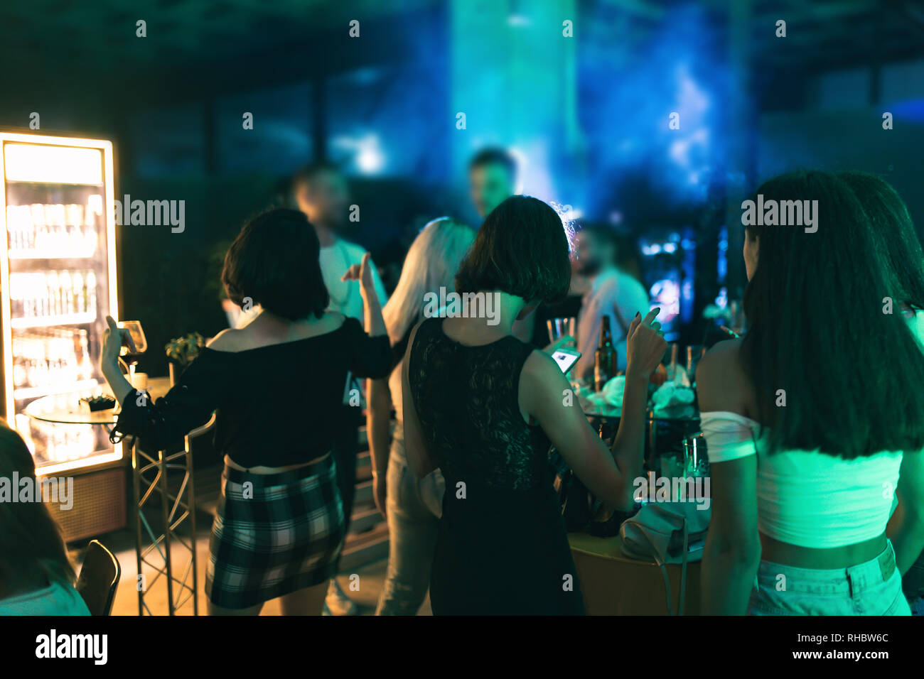 Young people and friends dancing and enjoying in the nightclub. People ...