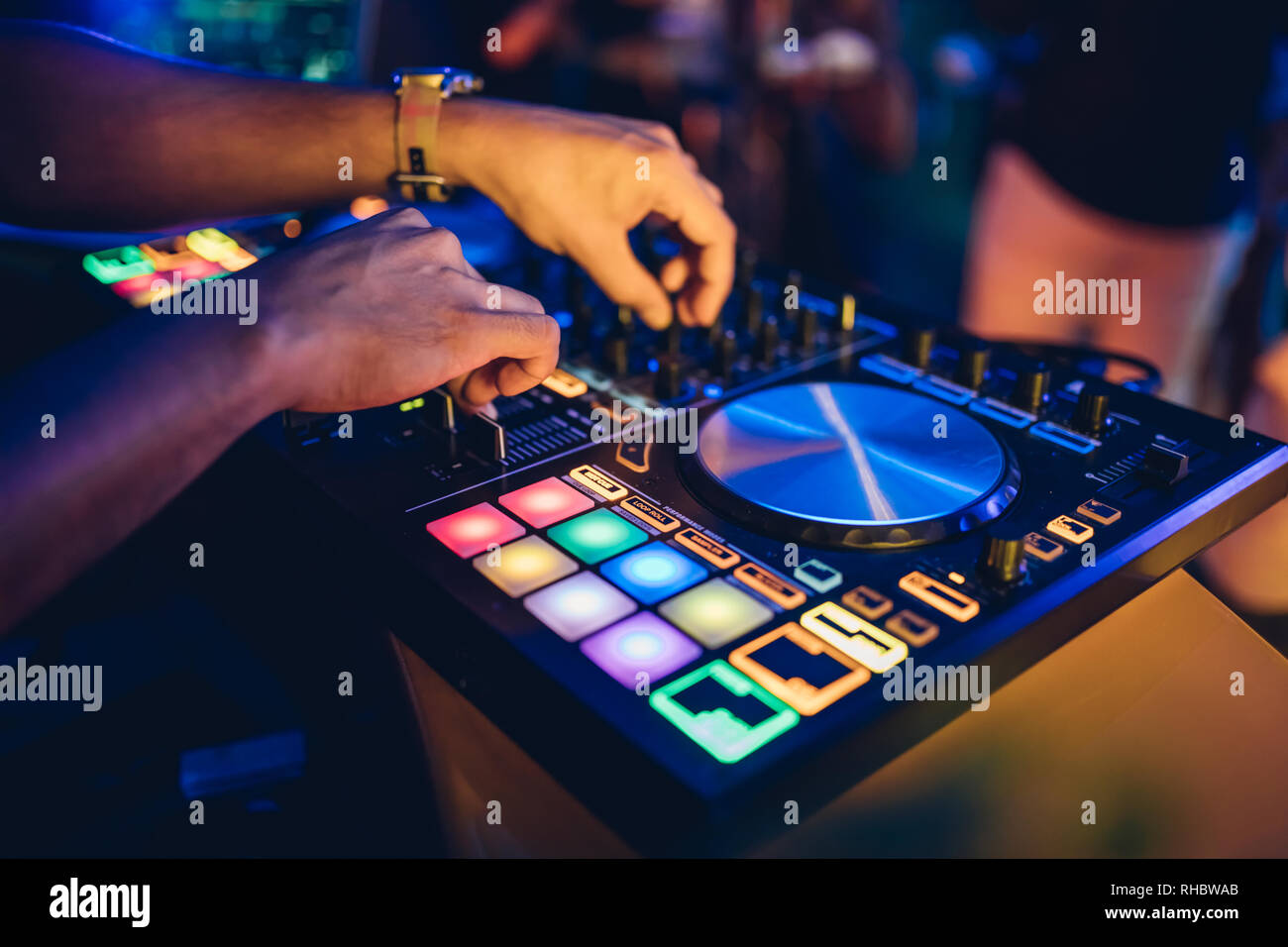 DJ plays live set and mixing music on turntable console at stage in the ...